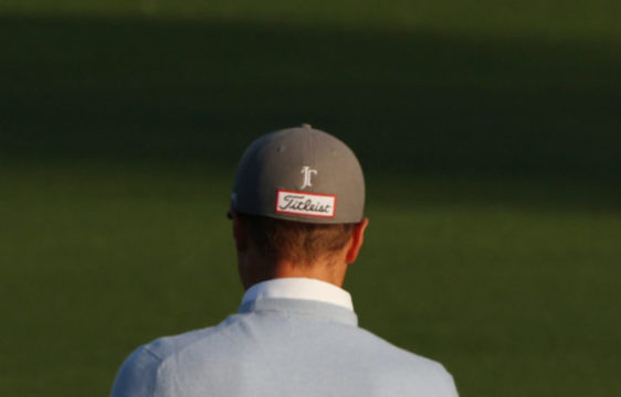 What's the logo on the back of Justin Thomas' hat?